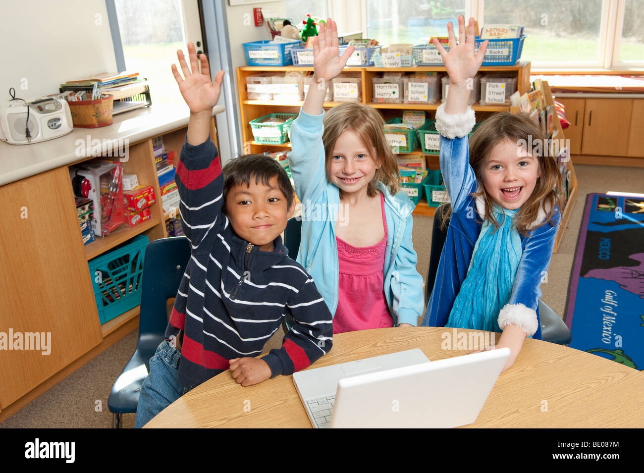 Students raising hands Stock Photo - Alamy