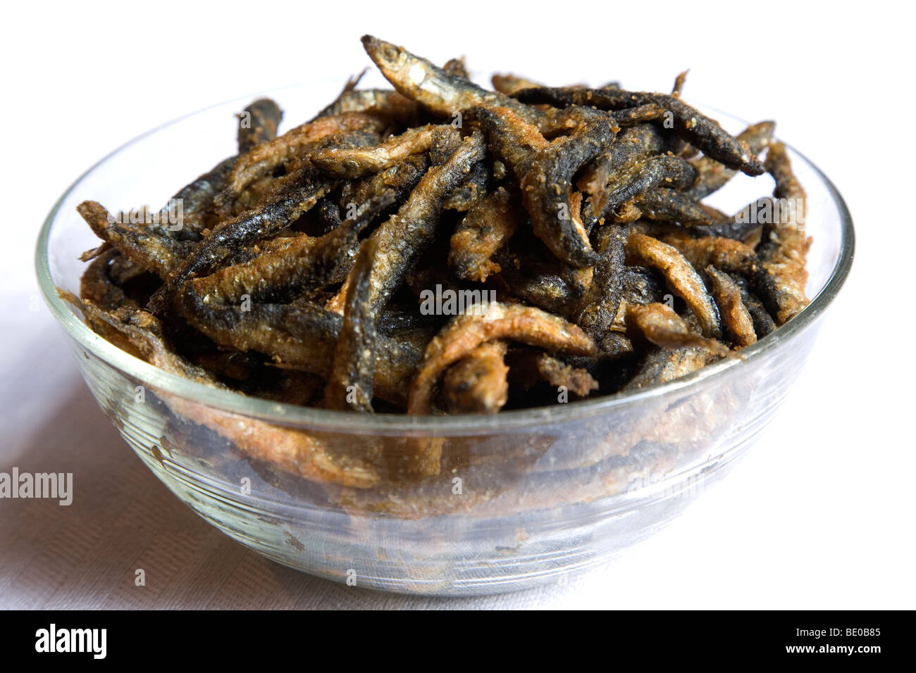 Fried Vendace, small freshwater fish, are offered in a bowl. The fish ...