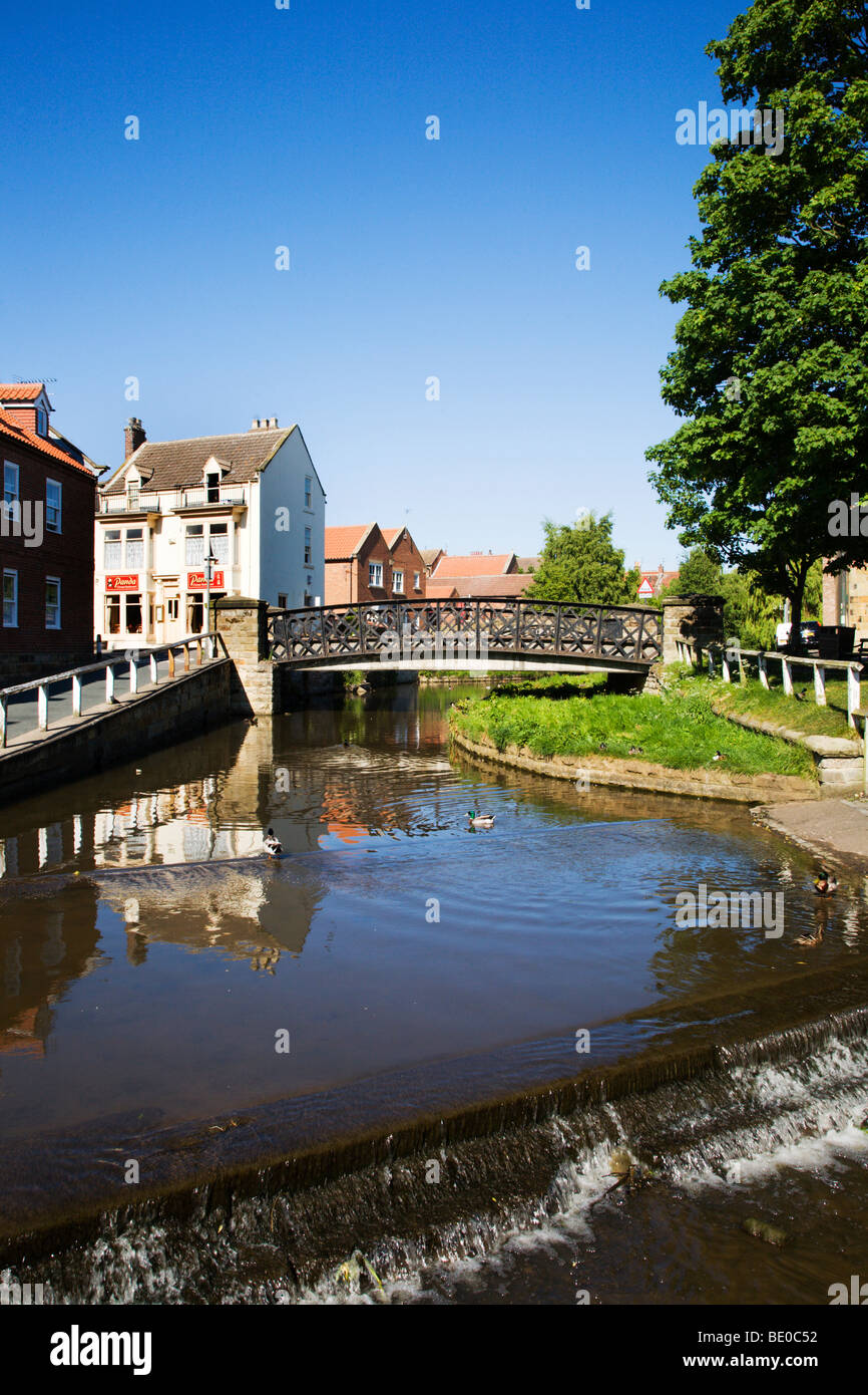 Weir and bridges over the River Leven Stokesley Yorkshire England Stock ...