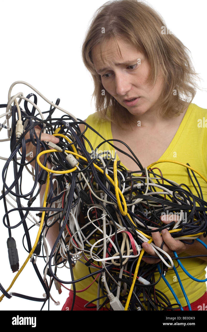 sad woman with tangle of cables and wires in hands isolated on white ...