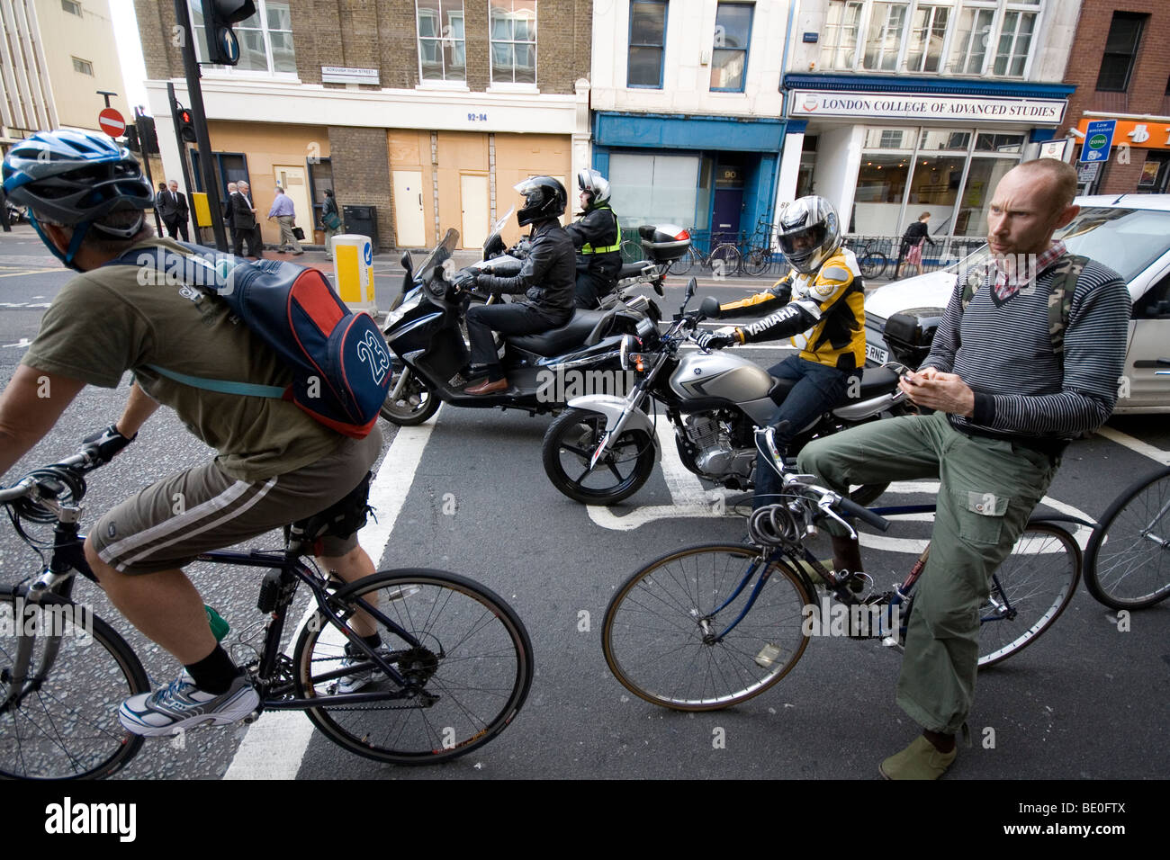 Motorcycles and bicycles wait at the traffic lights Stock Photo - Alamy