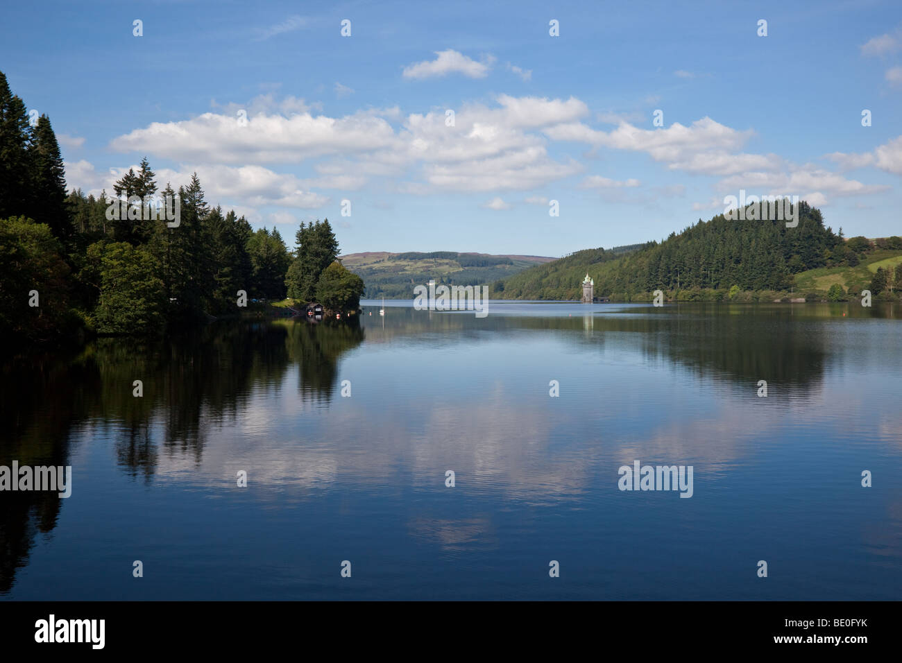Trees and the Victorian Straining Tower reflecting in the waters of ...