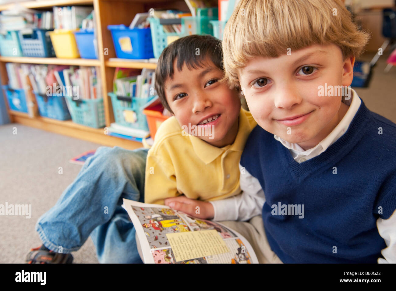 Students reading book together Stock Photo - Alamy