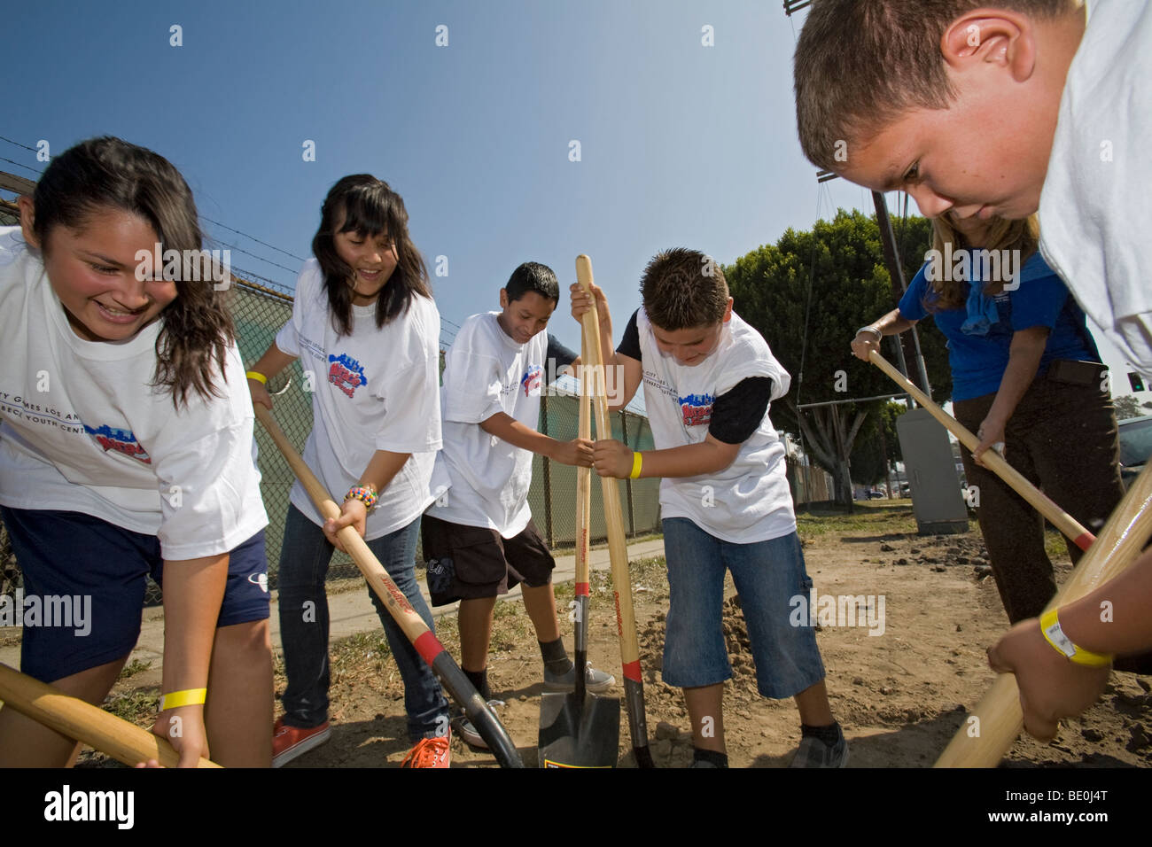 School Children dig hole at a tree planting along Mission Road in East ...