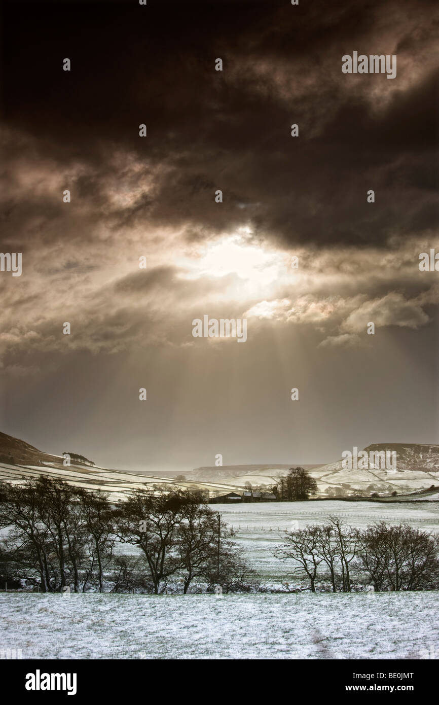 North Yorkshire, England; Sun shining over sepia-toned winter landscape ...