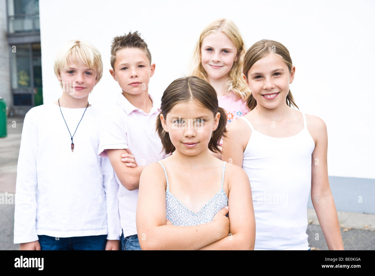 Five friends, arms folded, cool, in the schoolyard Stock Photo - Alamy