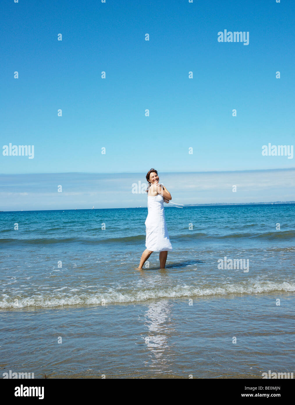 A woman dancing happily on the beach Stock Photo - Alamy