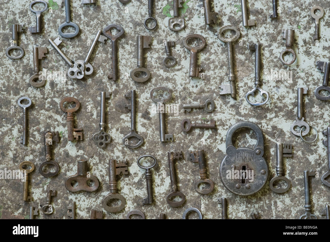 Group of ornate and antique keys with a single aged padlock arranged in ...