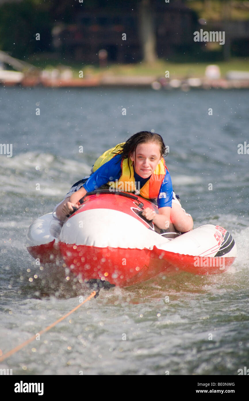 Teenager water surfing on a lake using a water craft - skibob - and ...