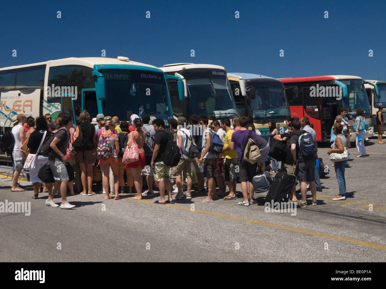 Crowd of people wait to get on a bus in Greece Stock Photo - Alamy