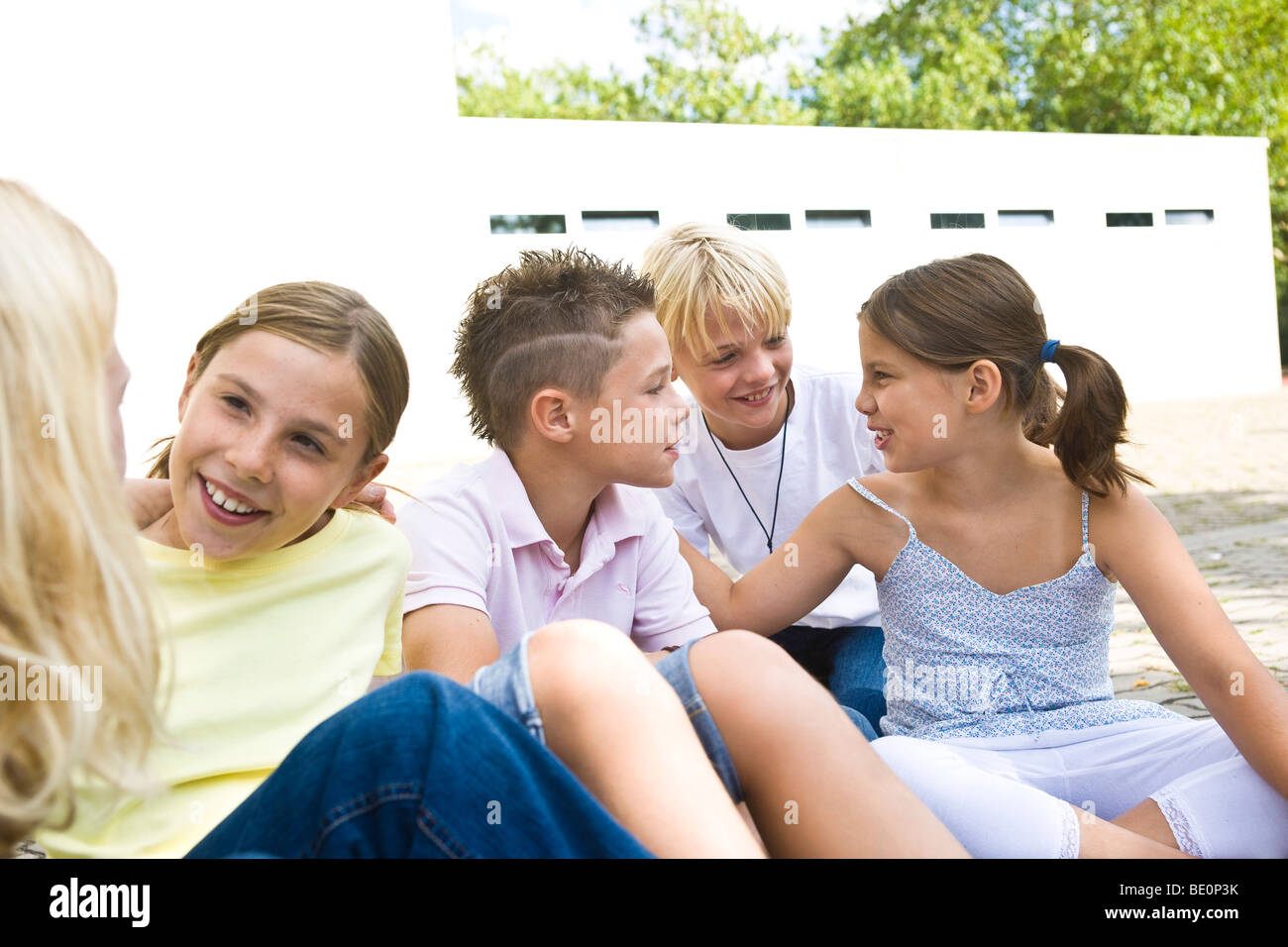 Five pupils talking in the schoolyard Stock Photo - Alamy