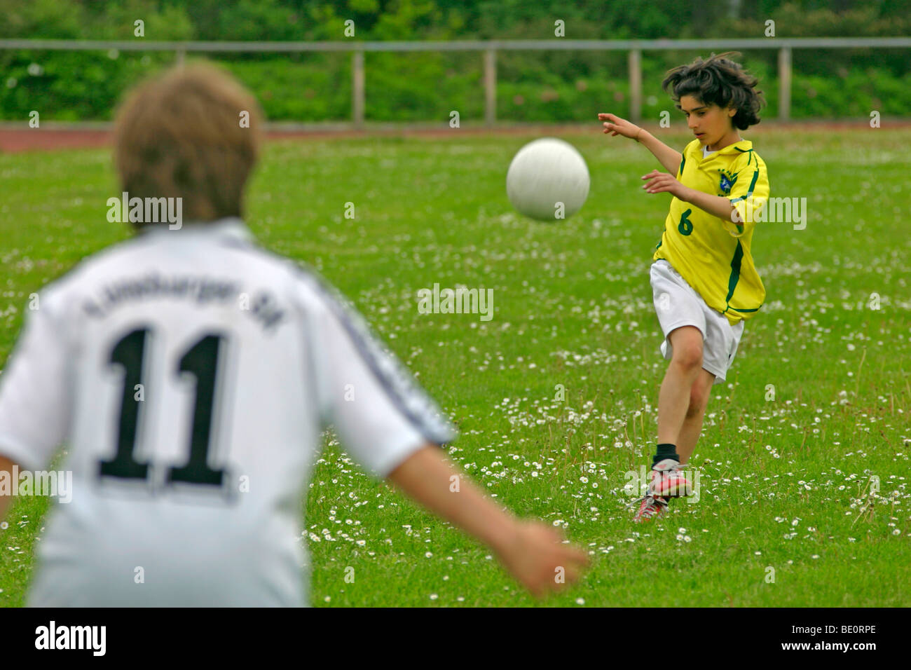 2 kids playing football hi-res stock photography and images - Alamy
