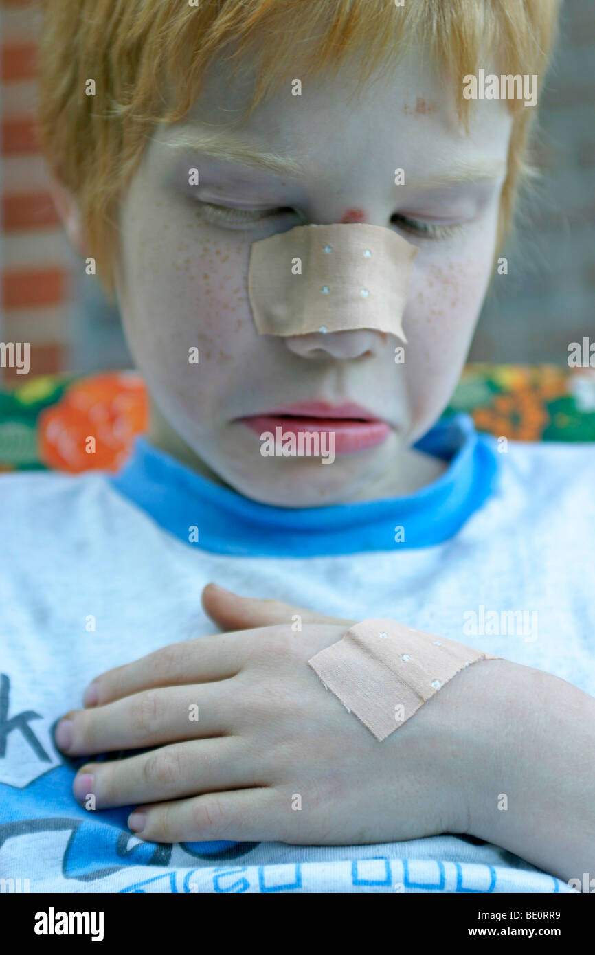 portrait of a young boy with a plaster Stock Photo - Alamy