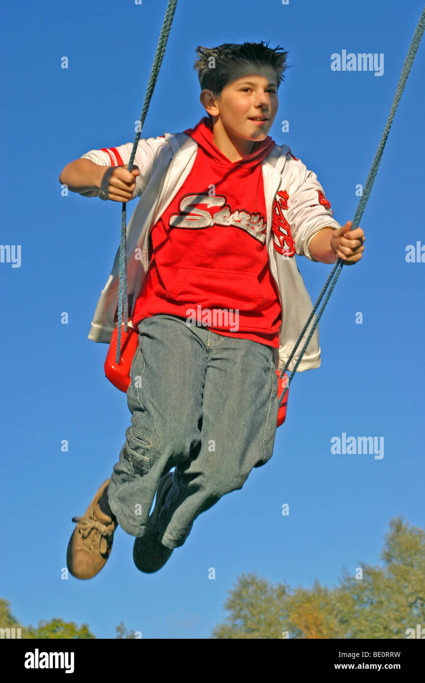 portrait of a young boy on a swing Stock Photo - Alamy