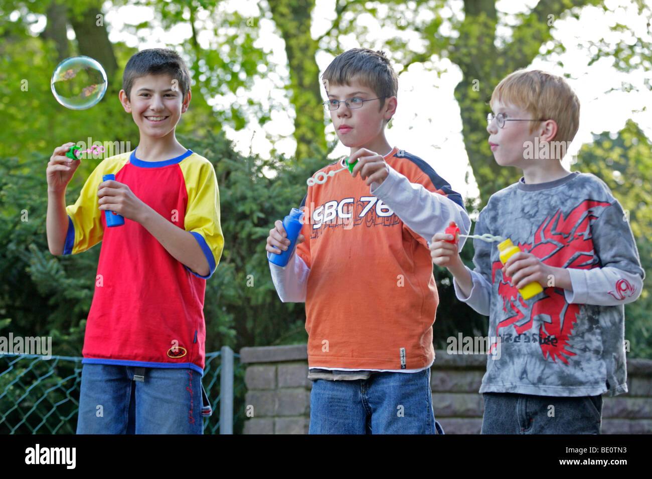 three boys making soap bubbles Stock Photo - Alamy