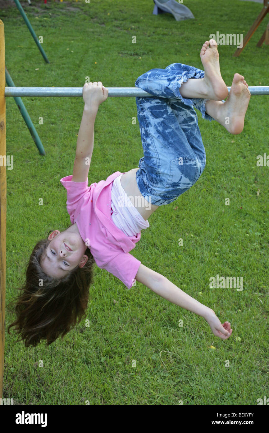 young girl on a high bar Stock Photo - Alamy