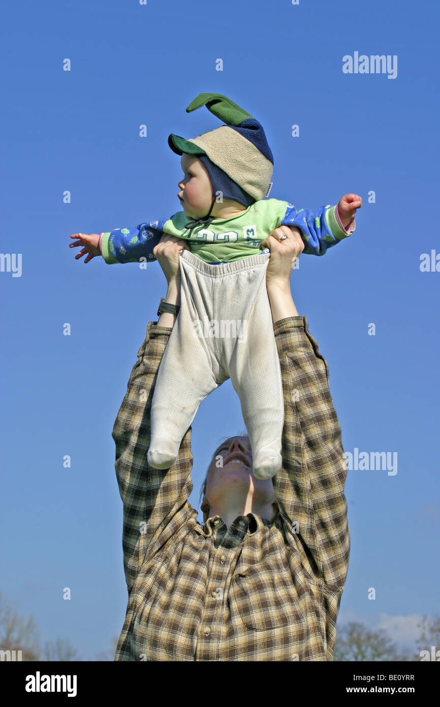 baby girl being held up in the air by her mother Stock Photo - Alamy