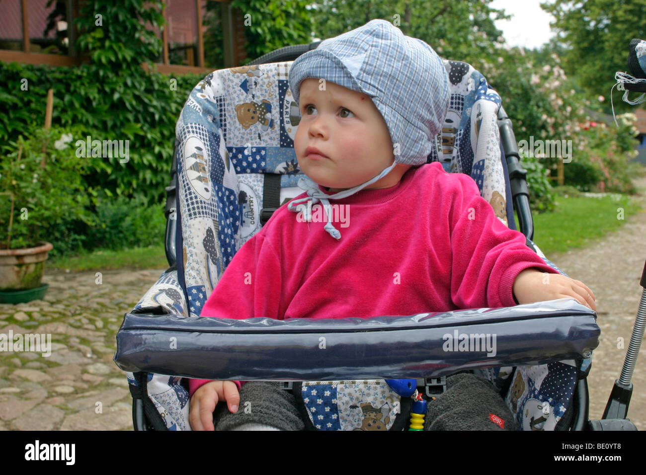 portrait of a baby girl sitting in her pram Stock Photo - Alamy