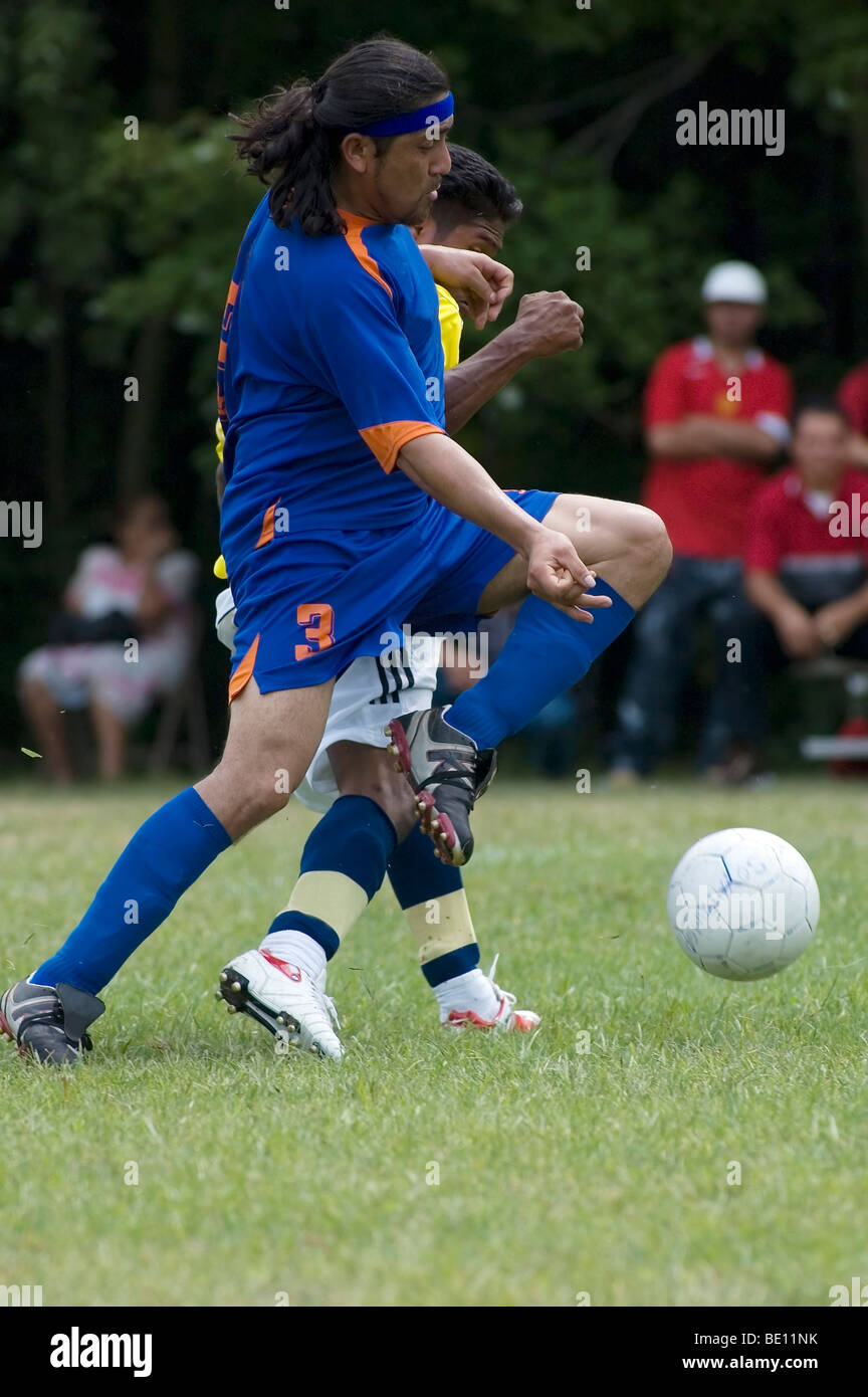 Two soccer players battle for possession of the ball Stock Photo - Alamy