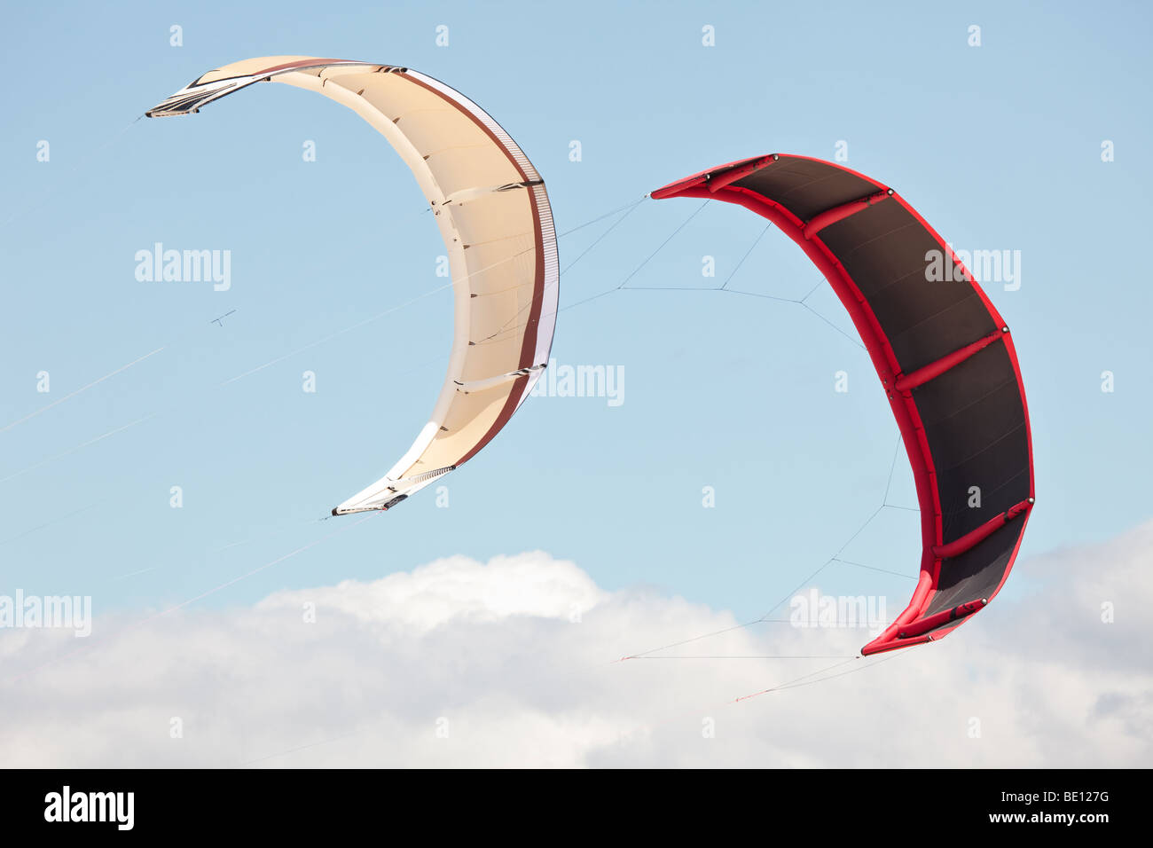 Two kiteboarding kites high in sky with clouds in background Stock ...