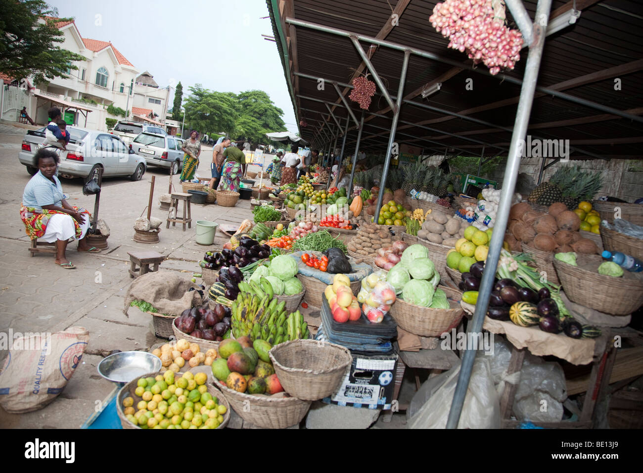 Women sell fruits and vegetables at the "Les Cocotier" market in ...