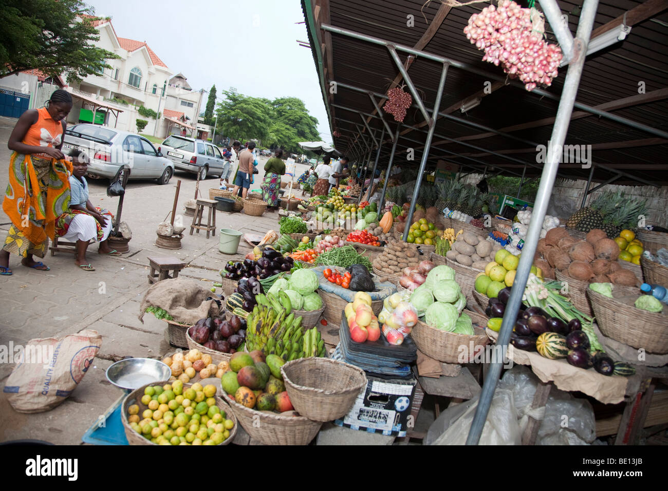 Women sell fruits and vegetables at the "Les Cocotier" market in ...