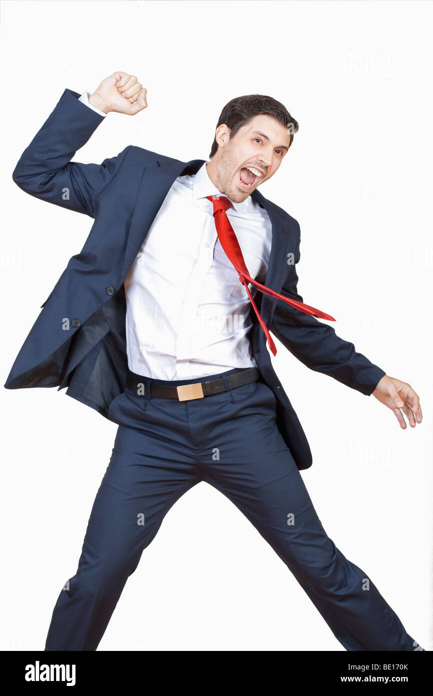 young business executive in suit cheering jumping in the air isolated ...