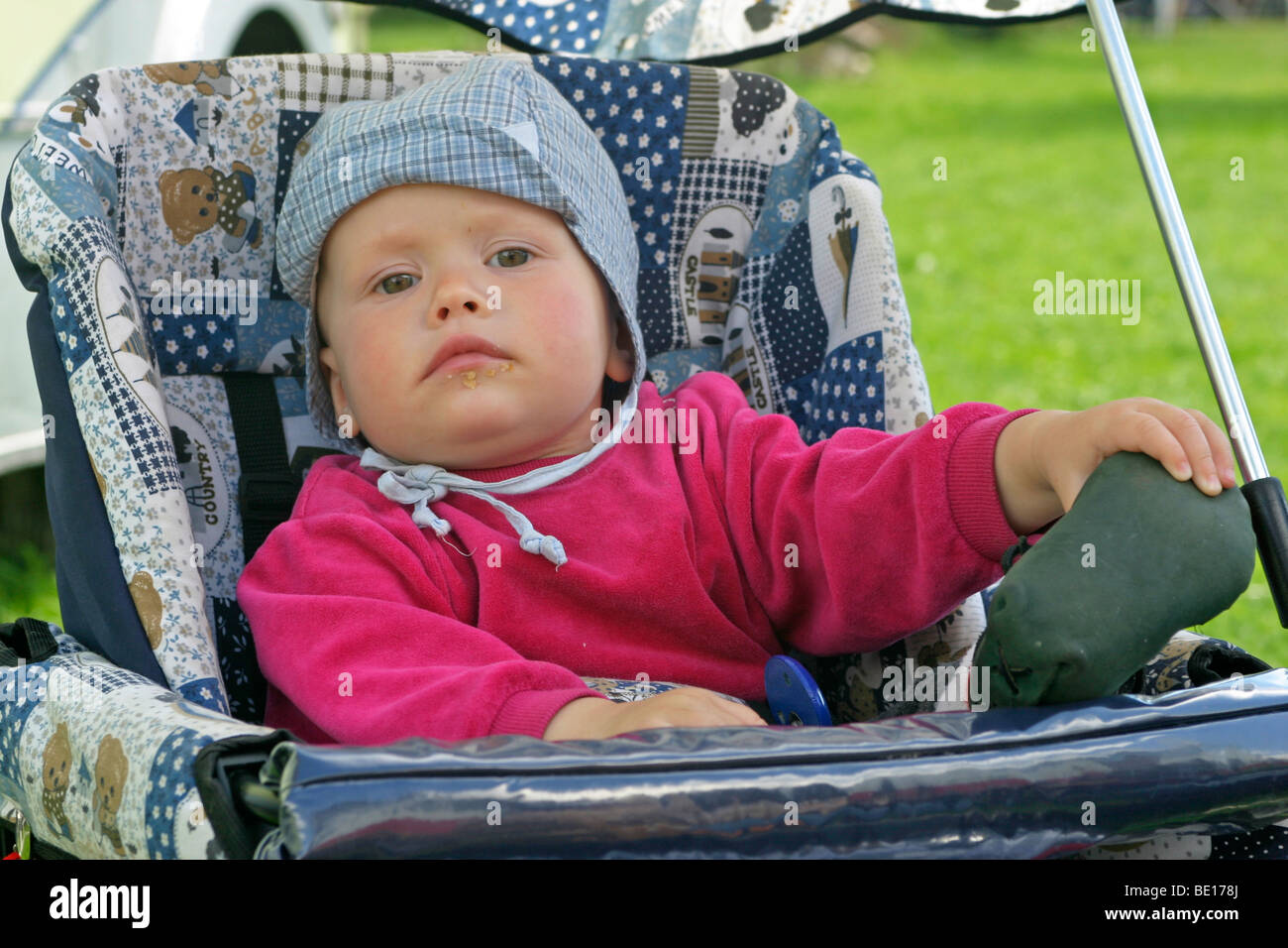 portrait of a baby girl sitting in her pram Stock Photo - Alamy