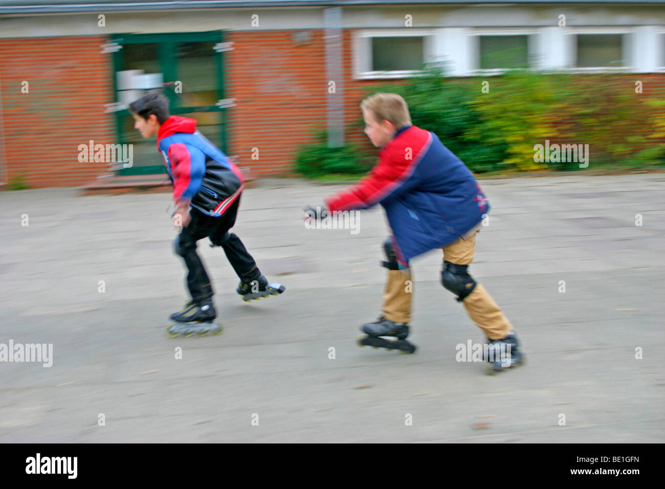 two young boys in-line skating Stock Photo - Alamy