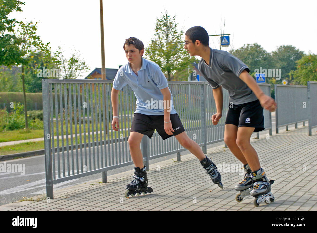 two young boys in-line skating together Stock Photo - Alamy