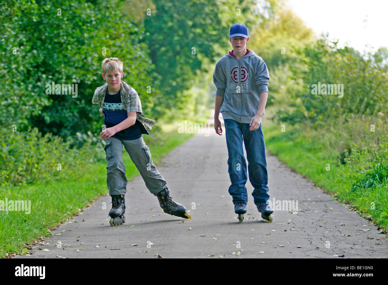 two young boys in-line skating together Stock Photo - Alamy