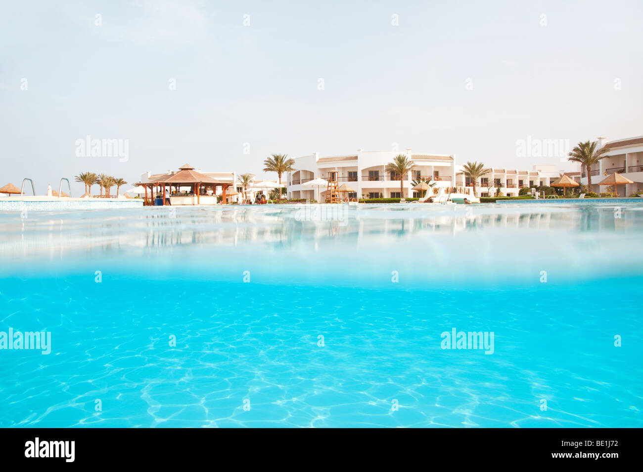 Tropical hotel swimming pool, low angle view from water surface Stock ...