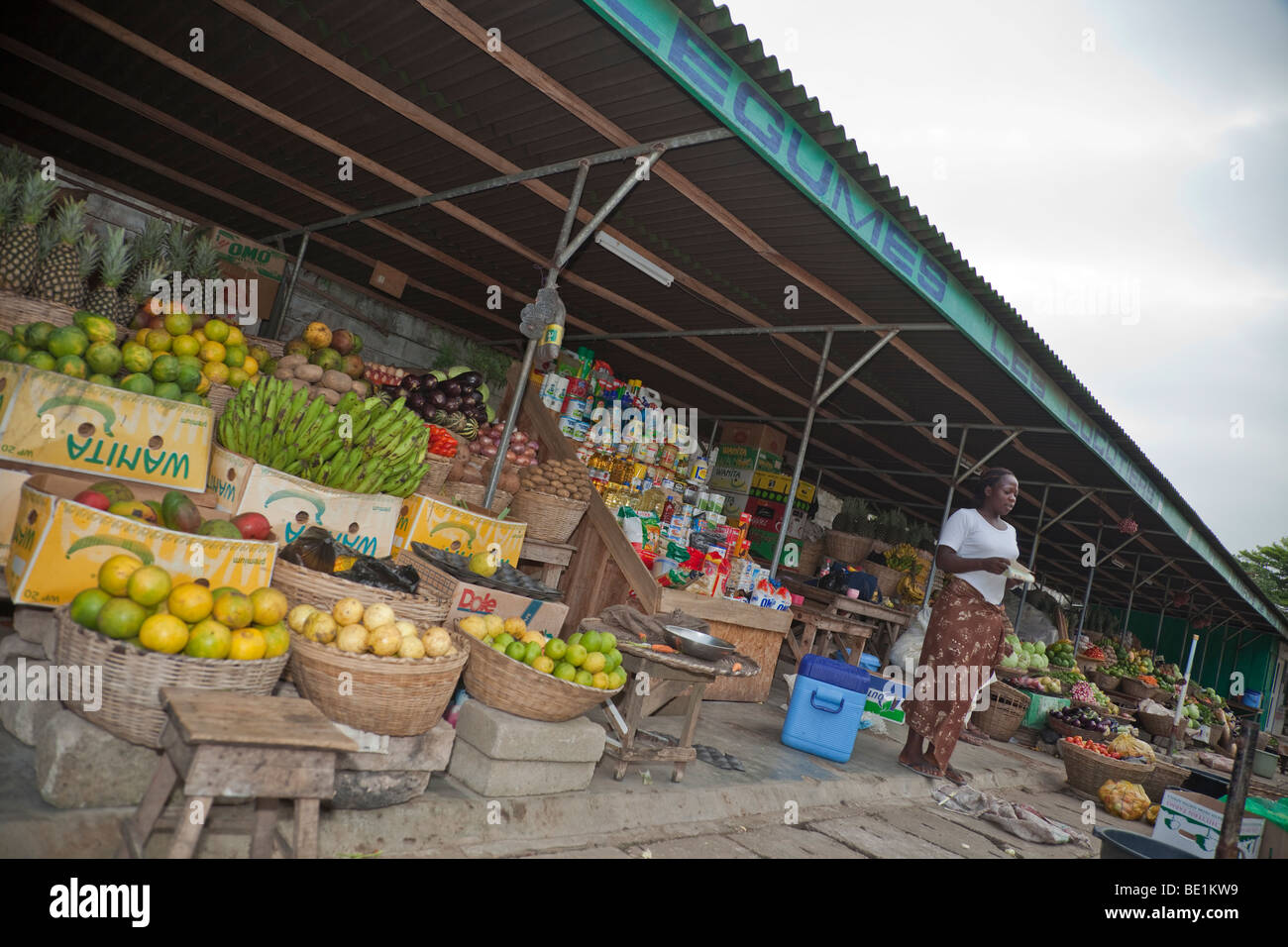 Women sell fruits and vegetables at the "Les Cocotier" market in ...