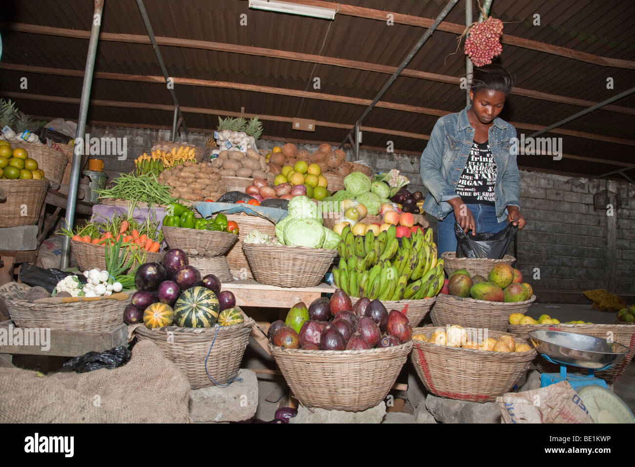 Women sell fruits and vegetables at the "Les Cocotier" market in ...