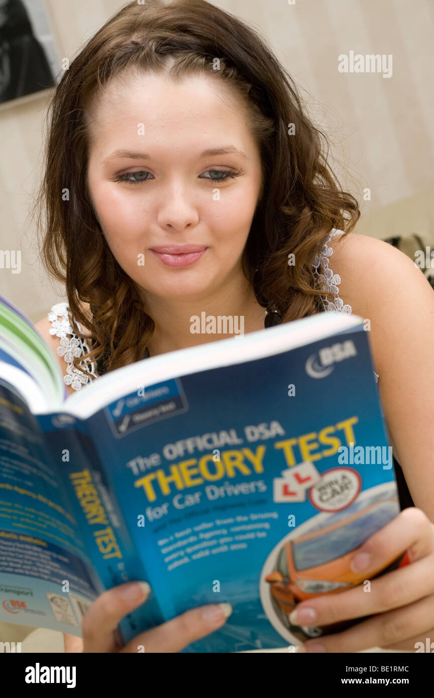 Teenage girl studying the official dsa theory test book for her driving ... Teenage girl studying the official dsa theory test book for her driving ...