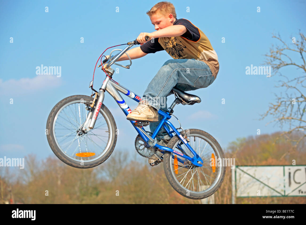 young boy jumping with his bike Stock Photo - Alamy
