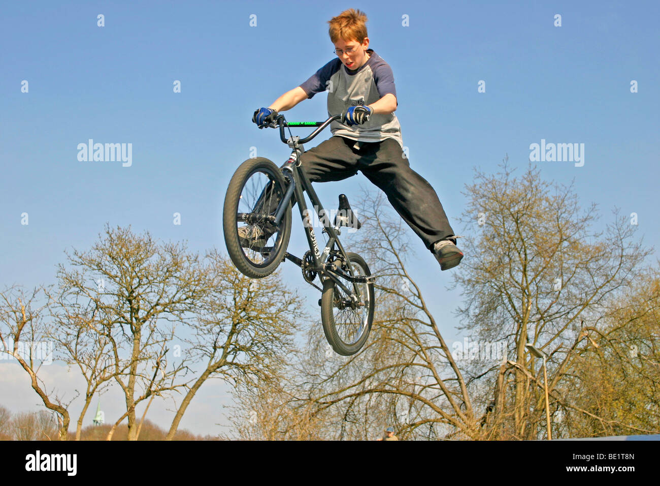 young boy jumping with his bike Stock Photo - Alamy