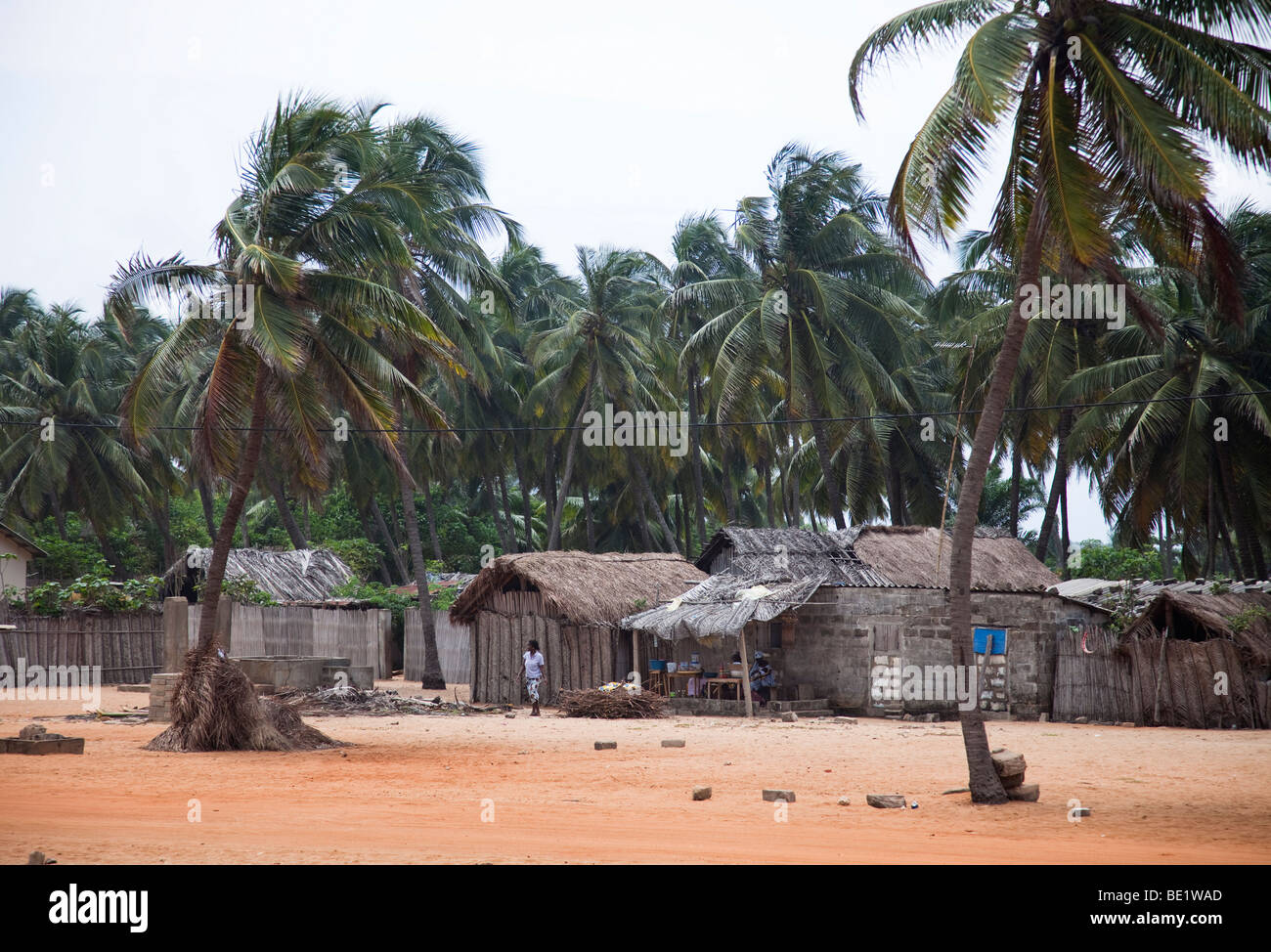 In the historic village of Ouidah, Benin, straw houses sit beneath the ...