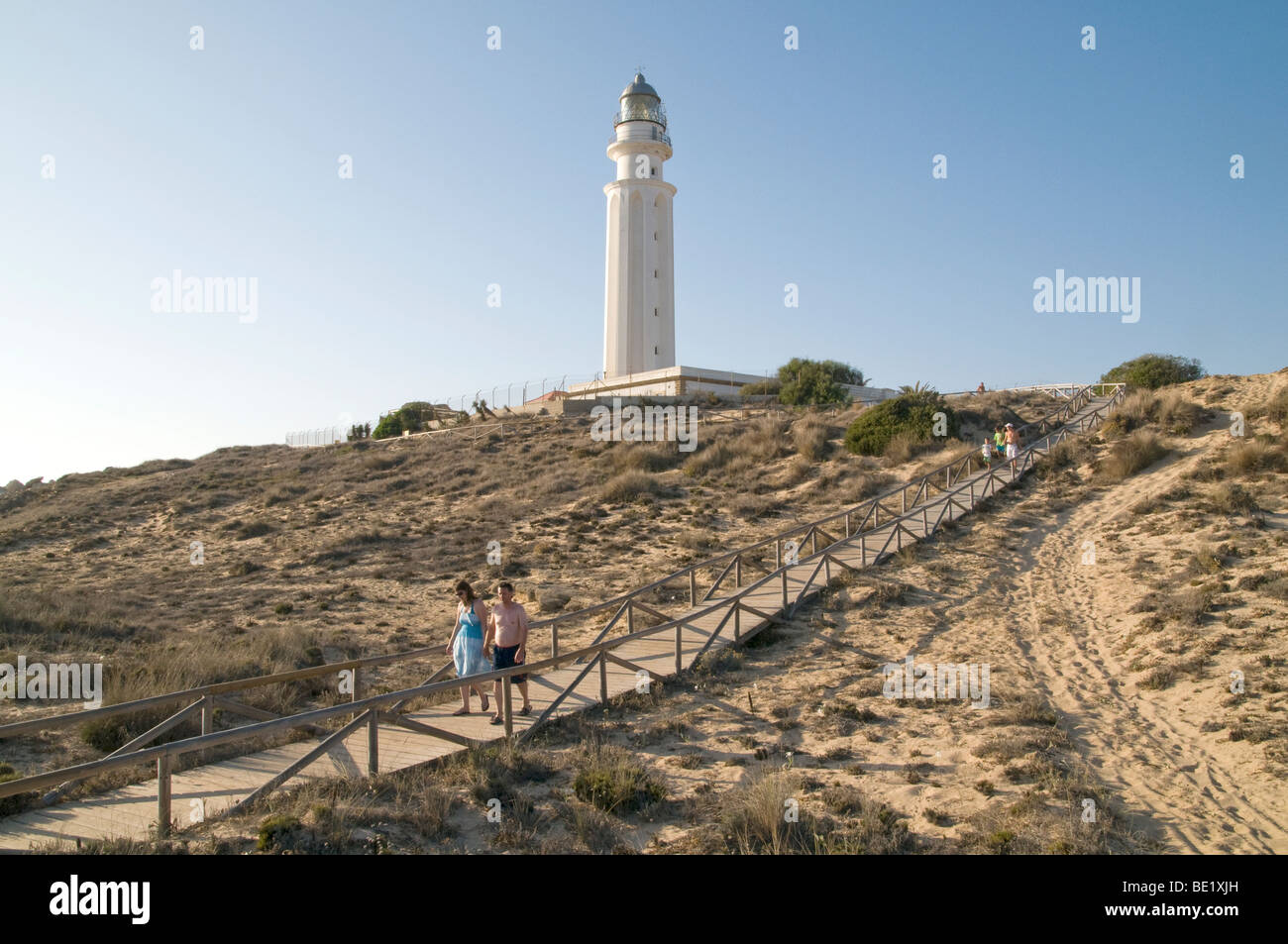 Spain. Tourists on the beaches by the lighthouse around Cape Trafalgar ...