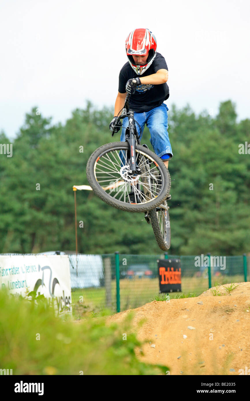 young boy jumping at a biking competition on a dirt track Stock Photo ...