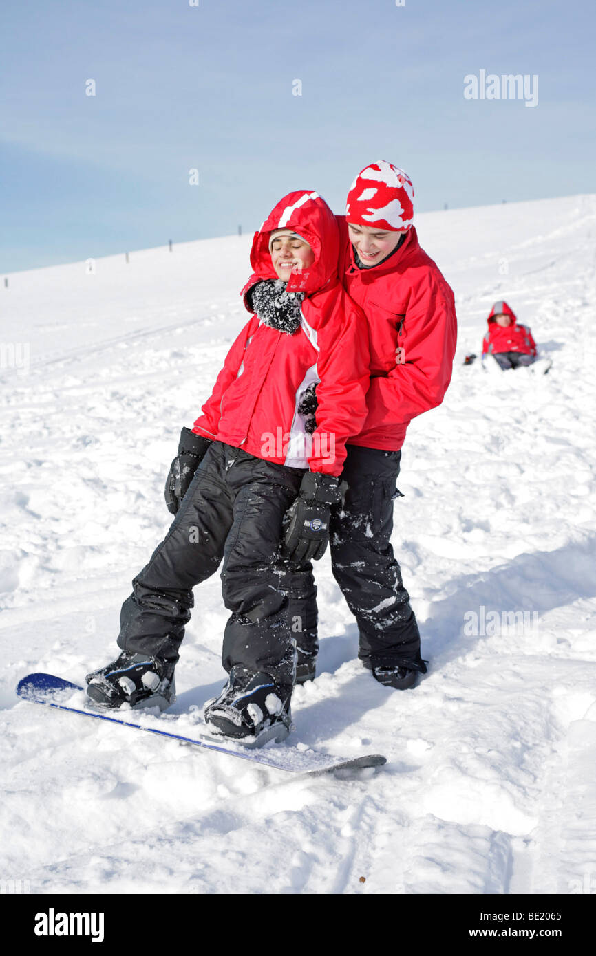 teenagers learning to snowboard Stock Photo - Alamy