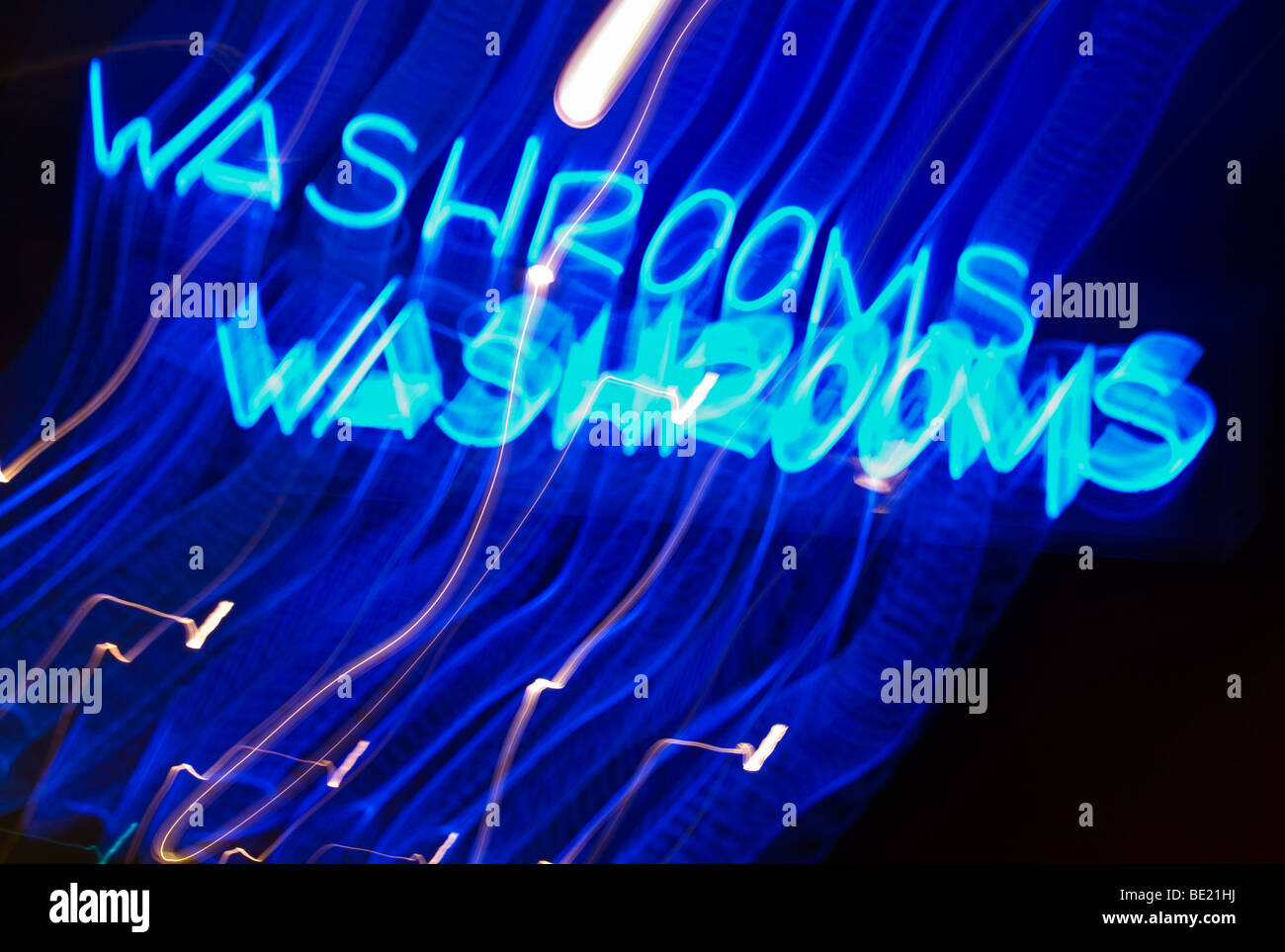 A blue neon Washroom sign suspended from the ceiling Stock Photo - Alamy