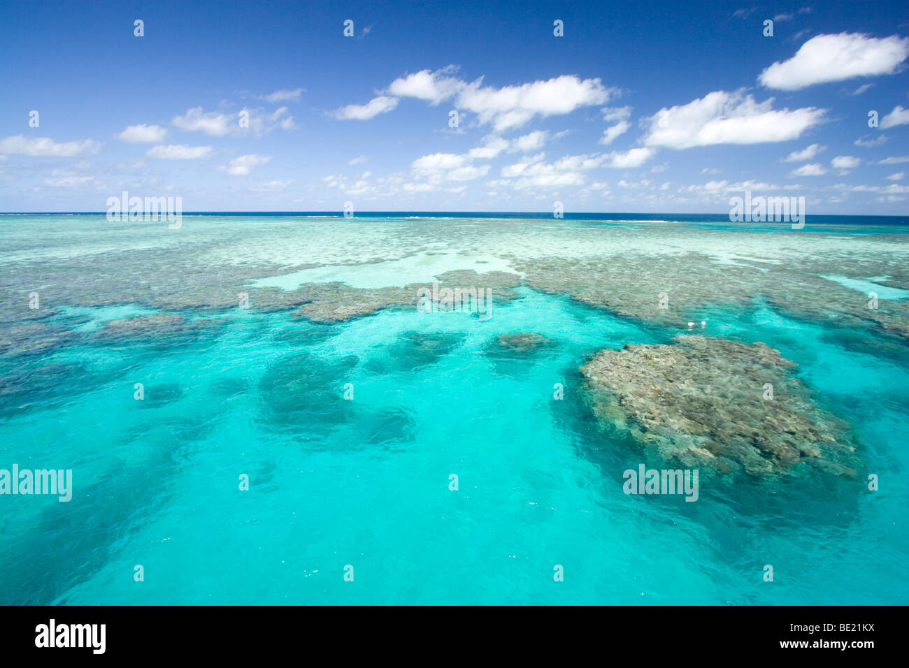 The crystal clear waters and coral of the Outer Great Barrief Reef off ...