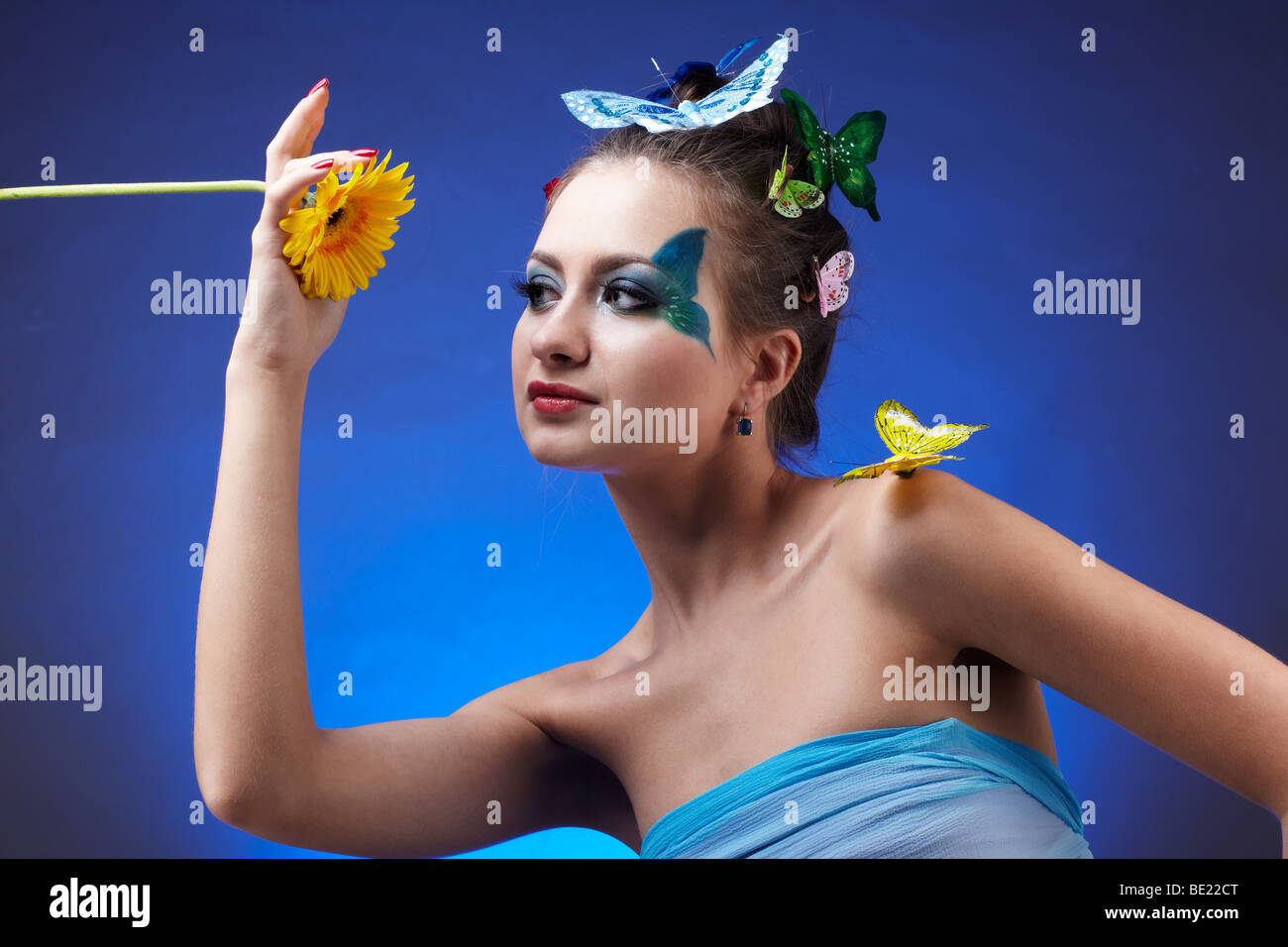 portrait of beautiful model with butterfly bodyart and artificail ...