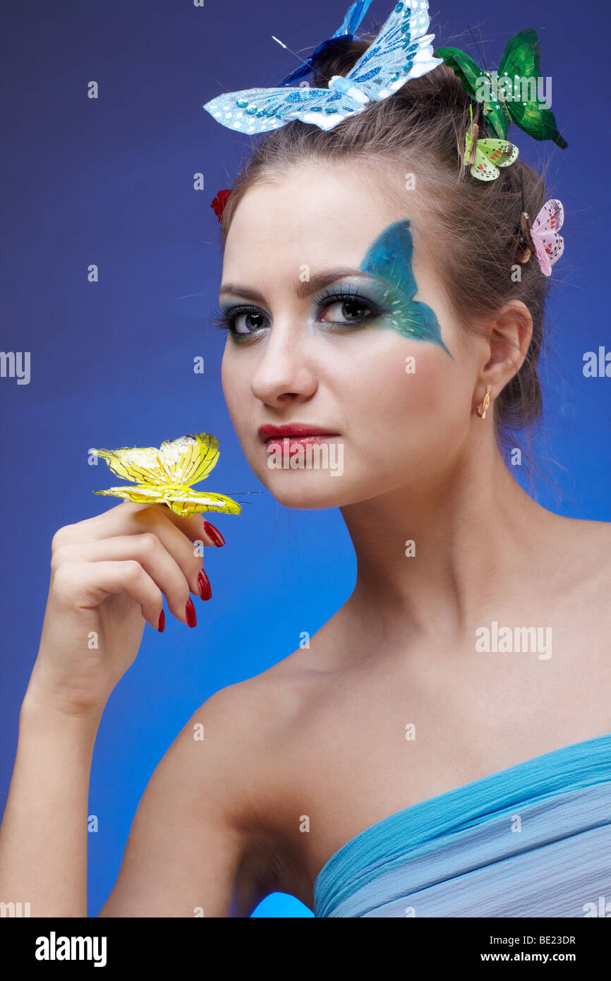 portrait of beautiful model with butterfly bodyart with artificail ...