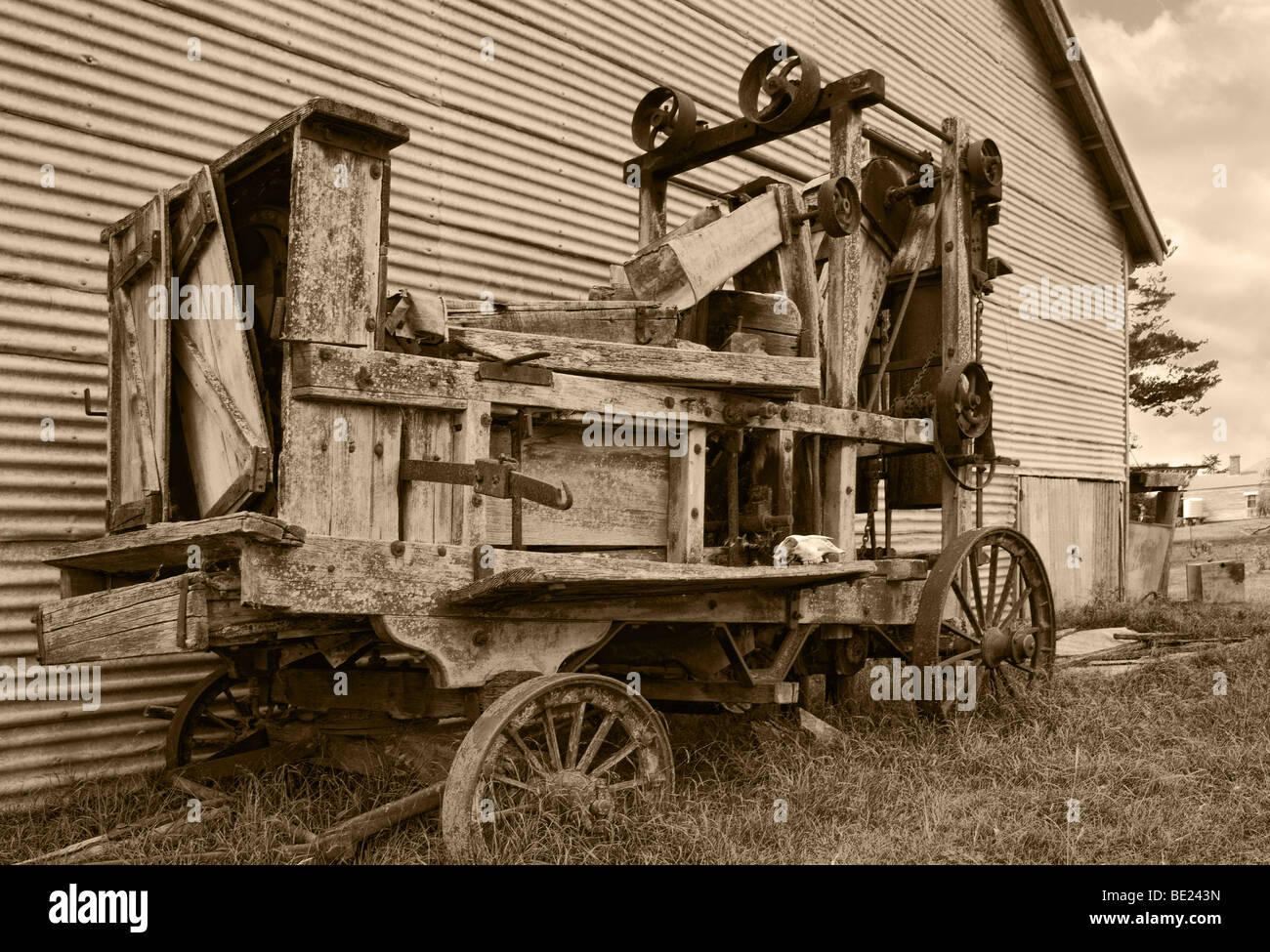 an old farm machinery baler in sepia Stock Photo - Alamy