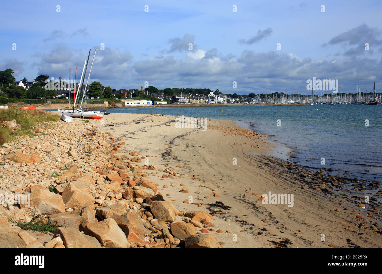 View of port and La Trinite Sur Mer from Plage du Port, La Trinite Sur ...
