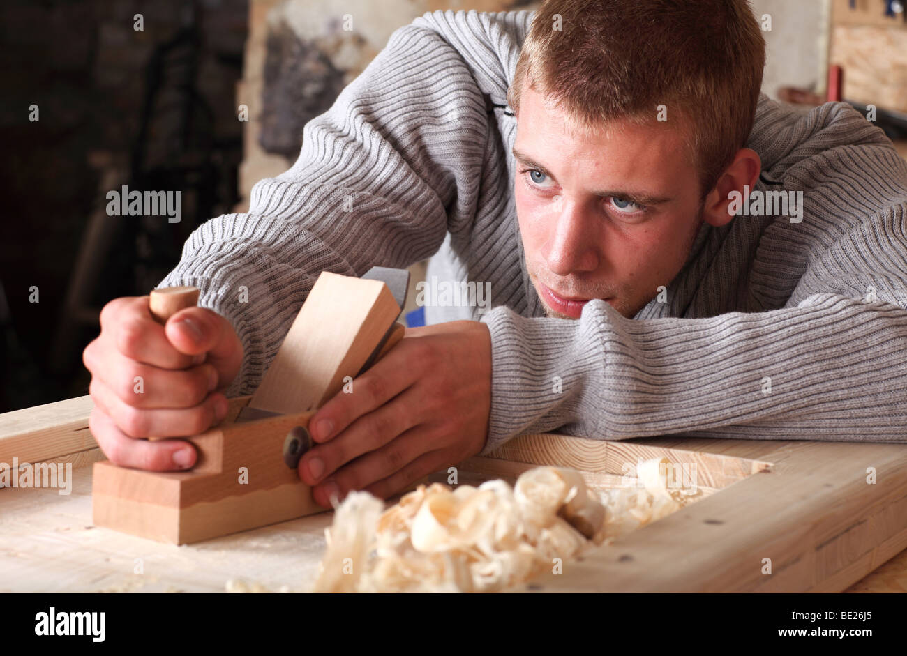 Young man using wood plane hi-res stock photography and images - Alamy