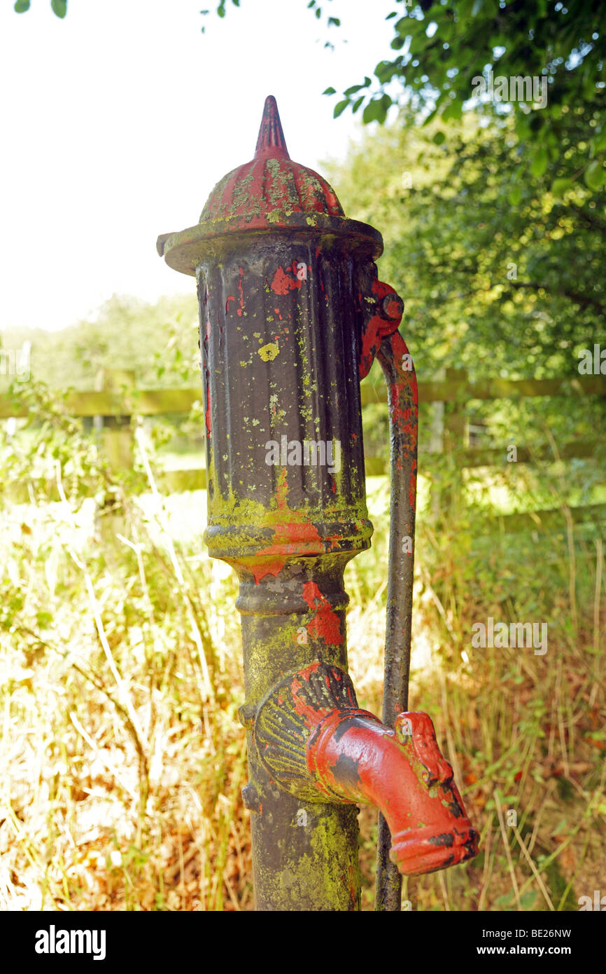 An ancient cast iron water pump near a stile Stock Photo - Alamy