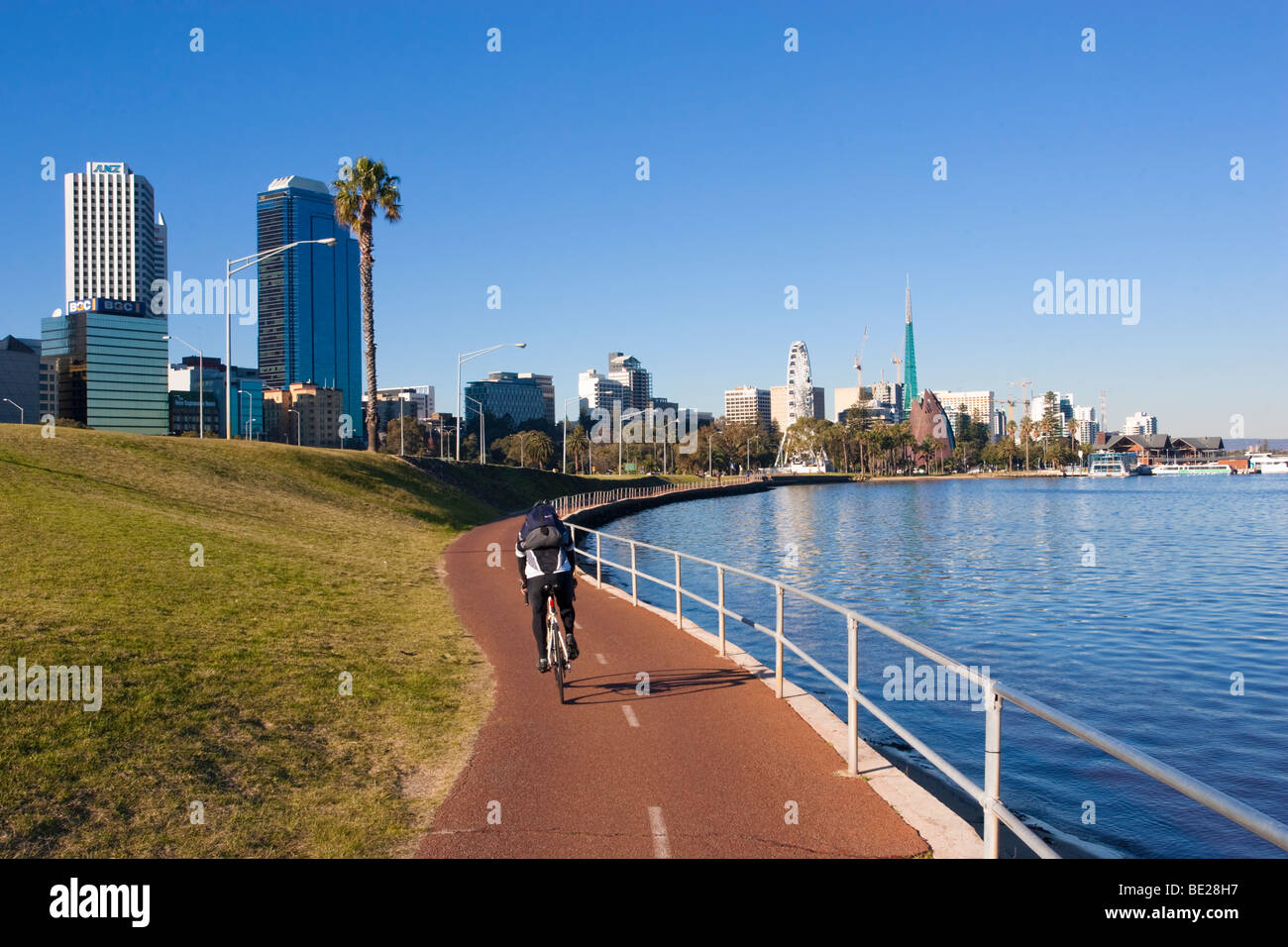 Man cycling down a cycle path towards the city. Perth, Australia Stock ...